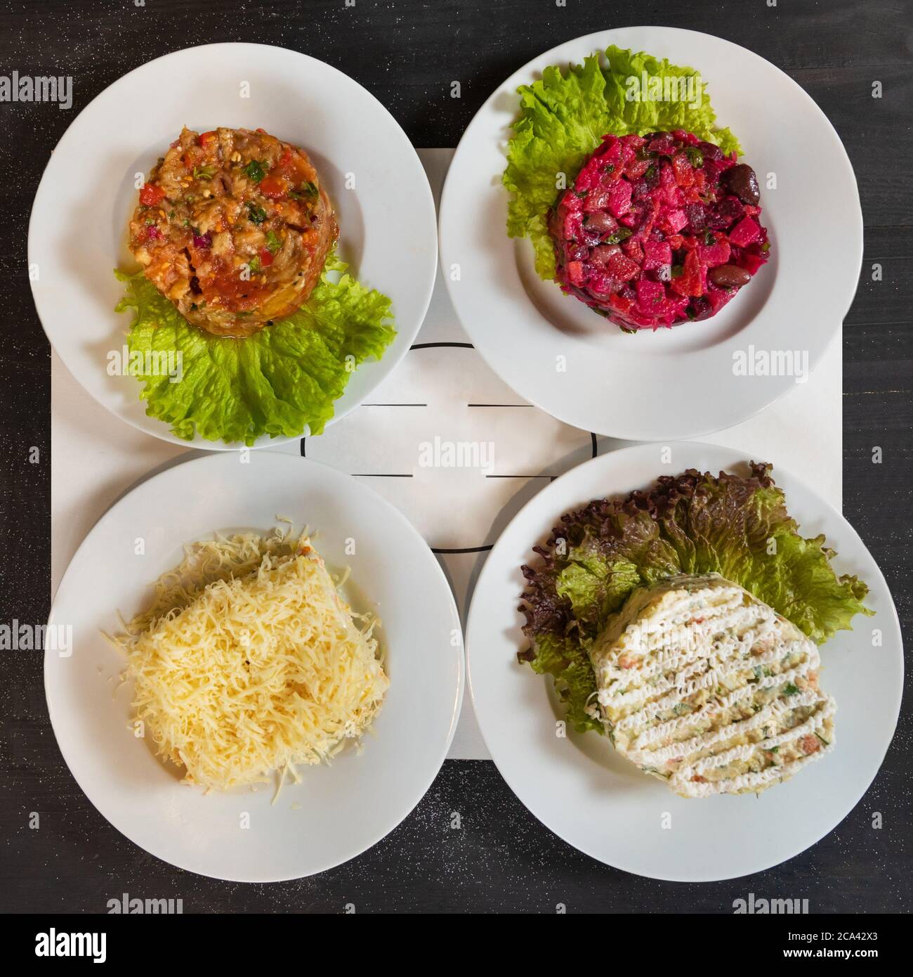 Tasty beetroot, eggplant, mimosa stolichny salad, top view Stock Photo ...