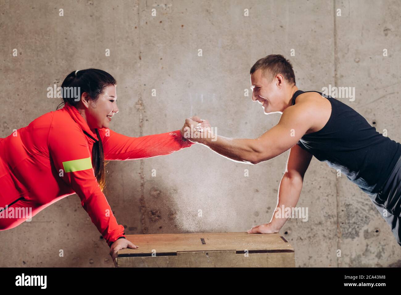 young funny man and woman doing push ups on one hand. motivation ...