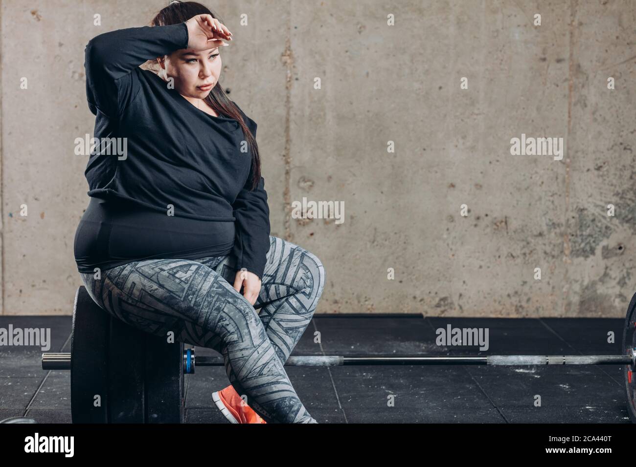 overweight woman looks tired after workout. close up photo. copy space ...