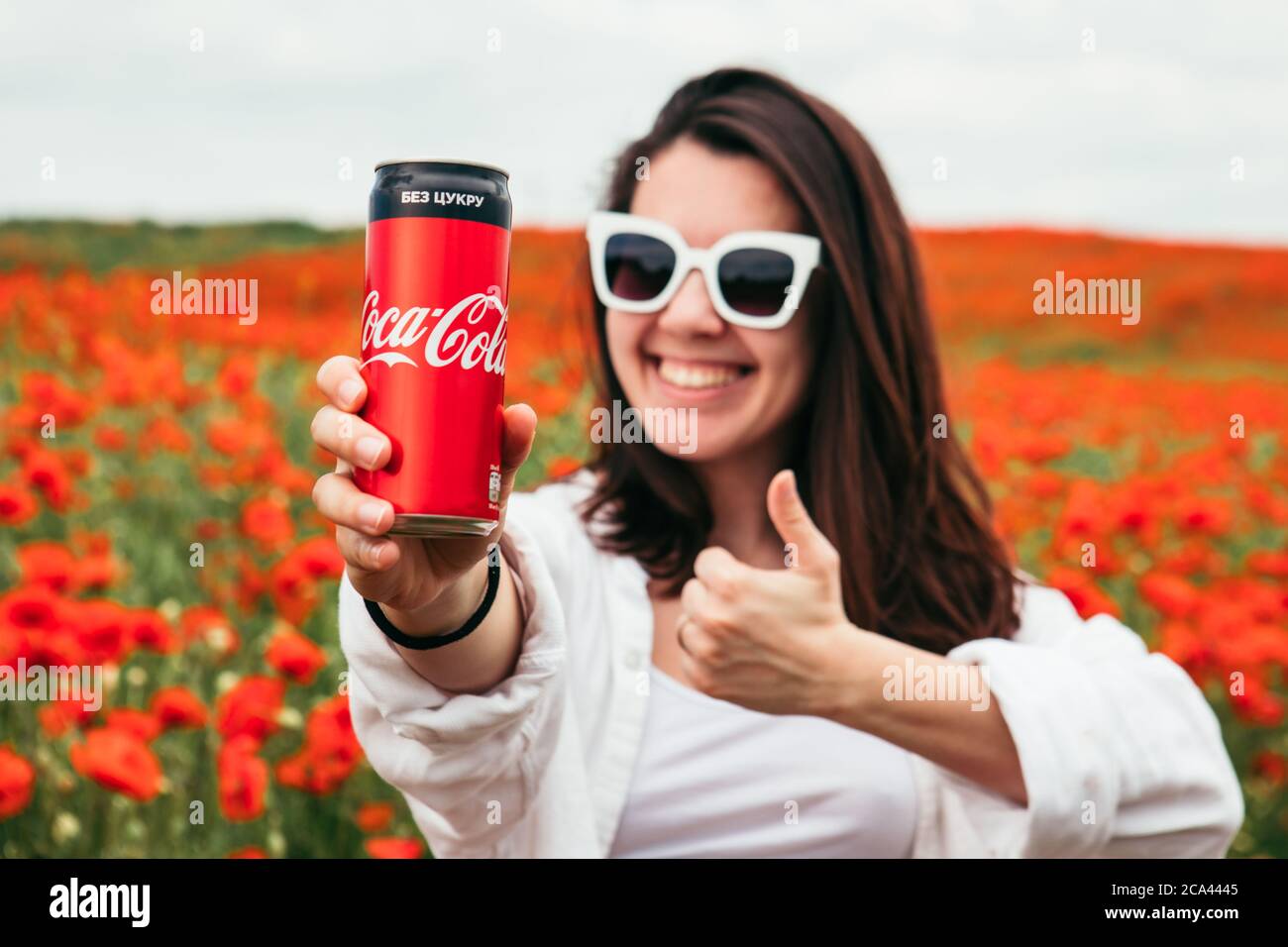 Lviv, Ukraine - Jun 11, 2020: Woman drinking coca cola standing at the ...