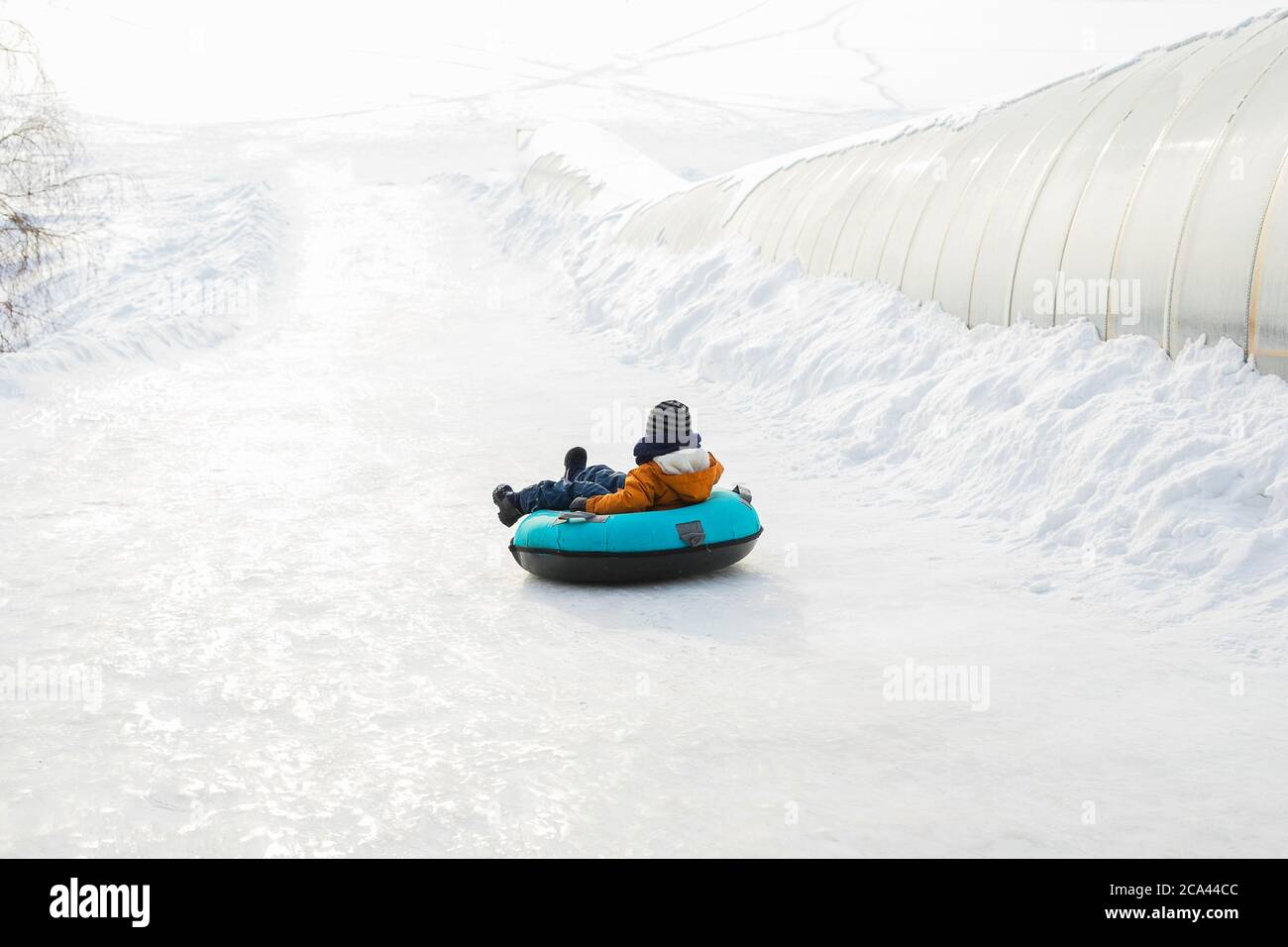Boy sledging down hill hi-res stock photography and images - Alamy