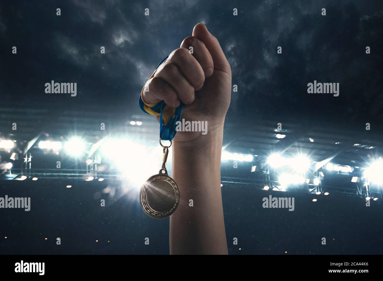 Champion. Award of victory, male hands tightening the golden medal of ...