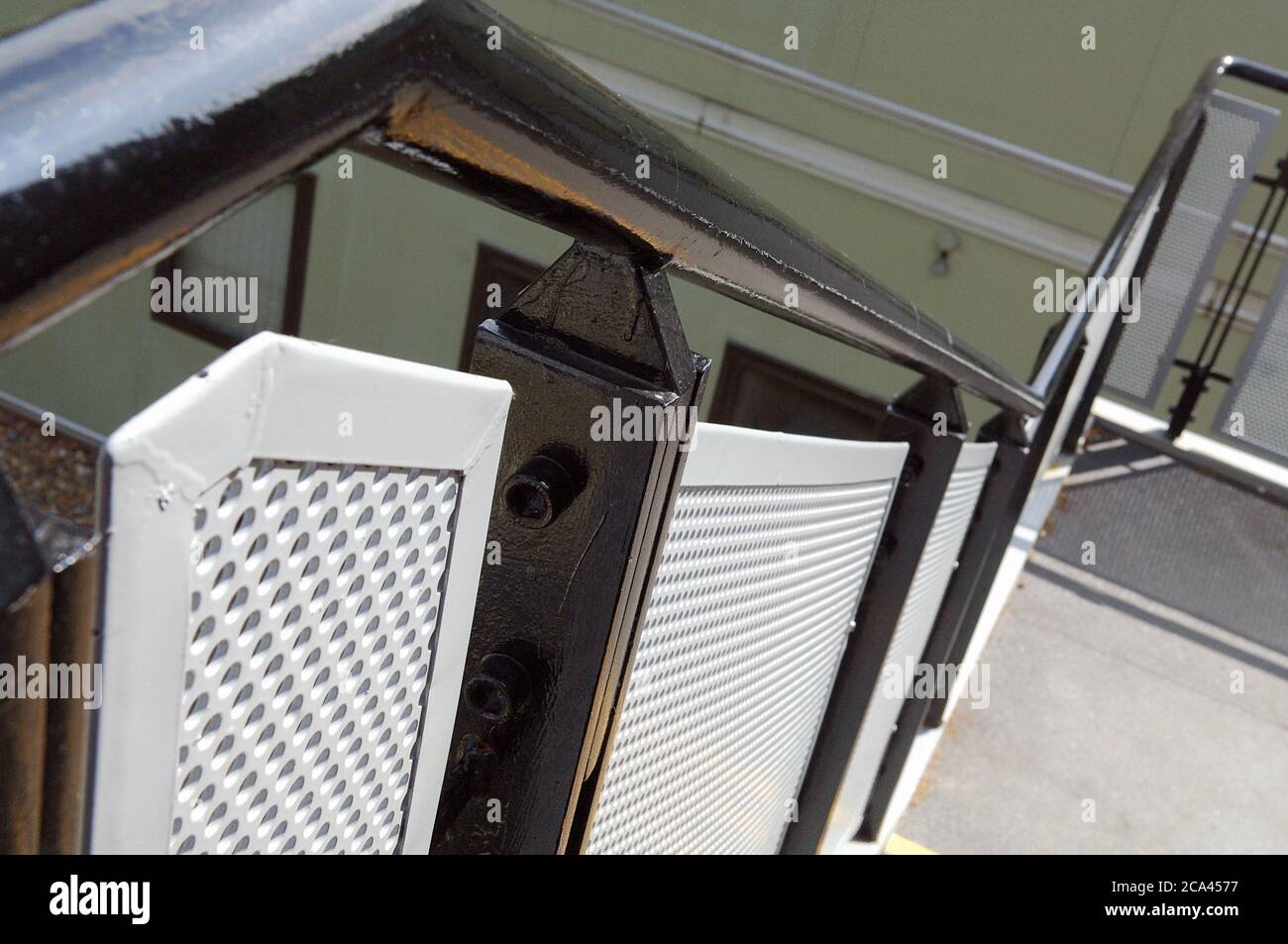 A black hand grip, hand rail, for steps Stock Photo - Alamy