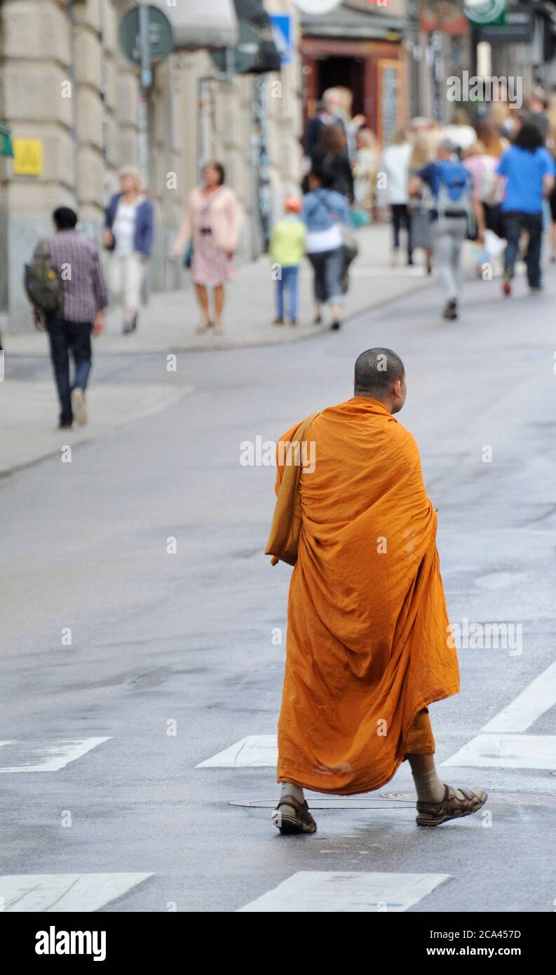 Buddhist monk walking on a street in the Sodermalm Quarter. Stockholm ...