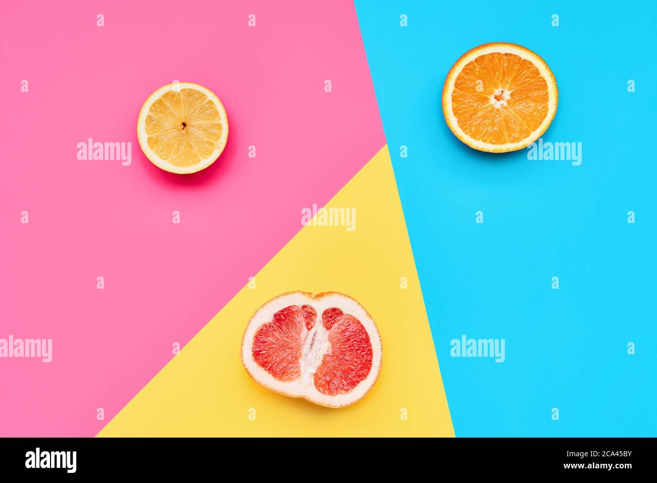 Citrus fruits on abstract geometry colored paper texture minimalism ...