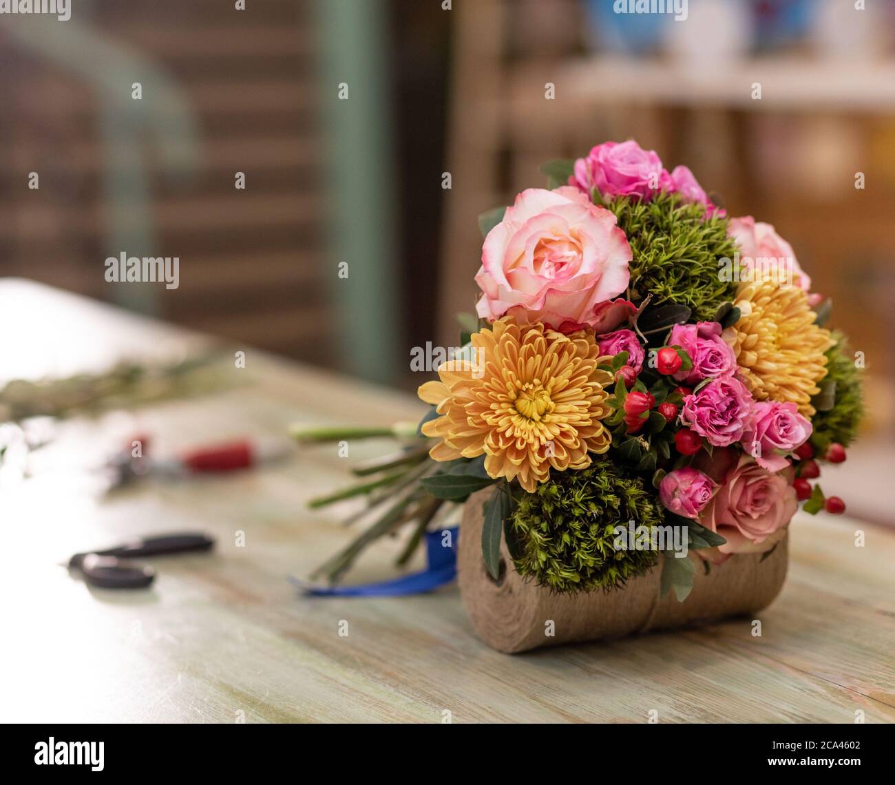Beautiful flower bouquet in the table with bouquet florist equipments ...