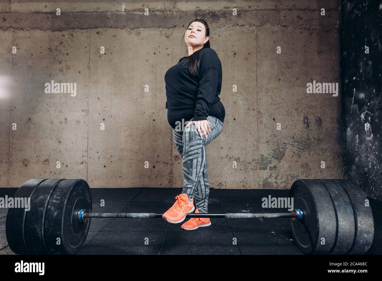 beautiful obese model in sportswear is going to go in for bodybuilding ...