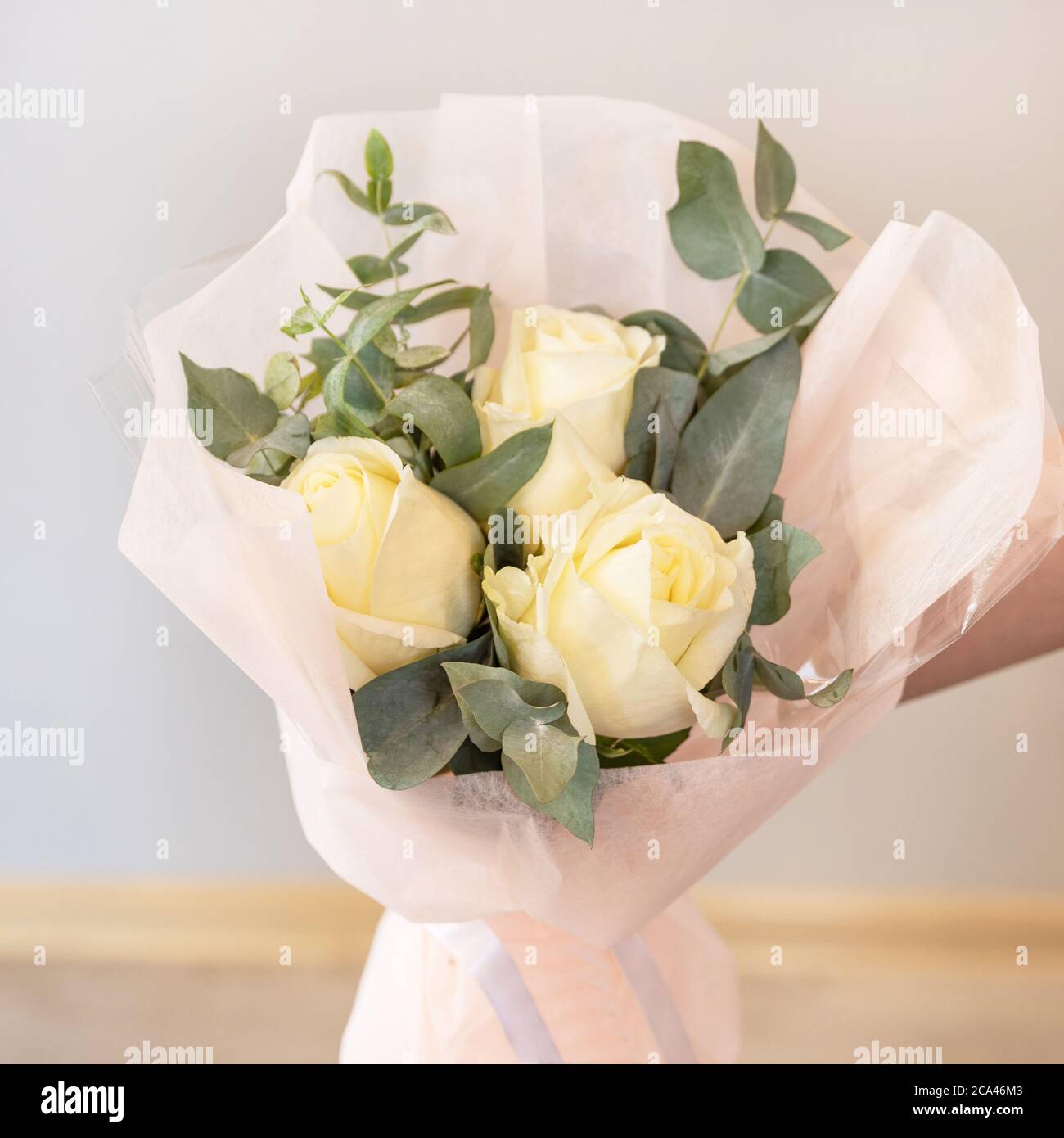 Woman holding white flower bouquet with white background Stock Photo ...