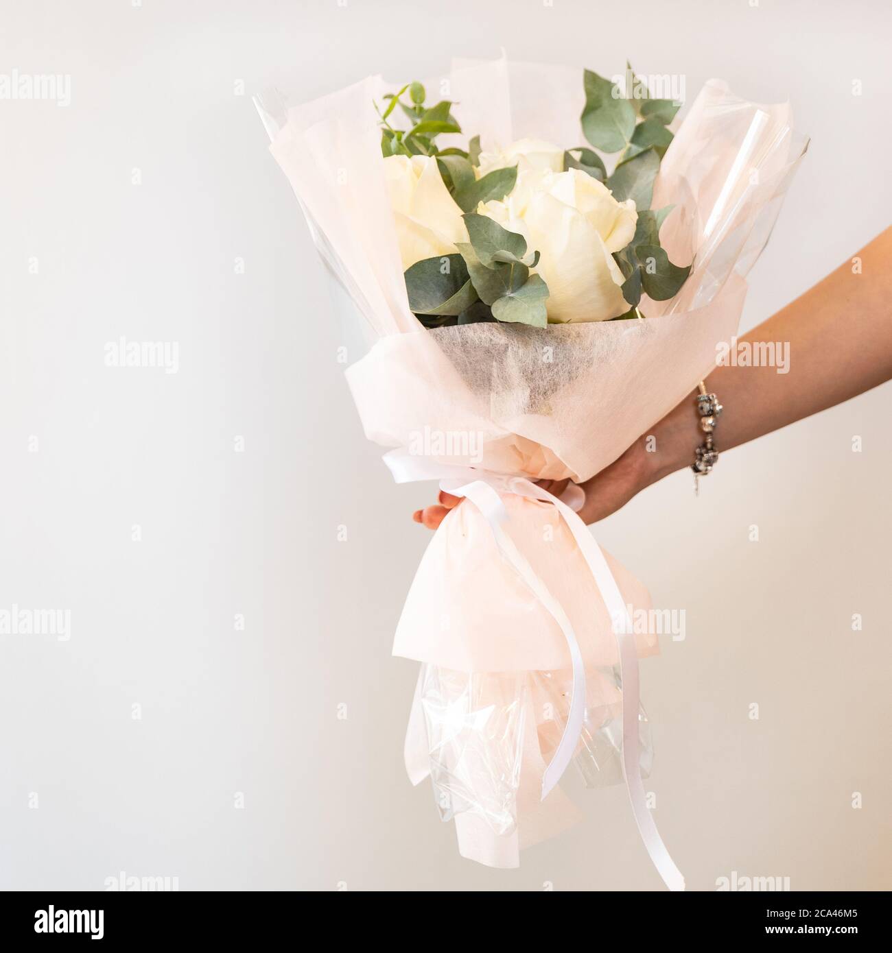 Woman holding white flower bouquet with white background Stock Photo ...