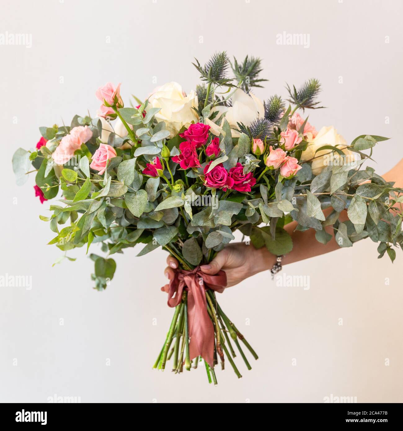Beautiful woman holding gerbera hi-res stock photography and images - Alamy
