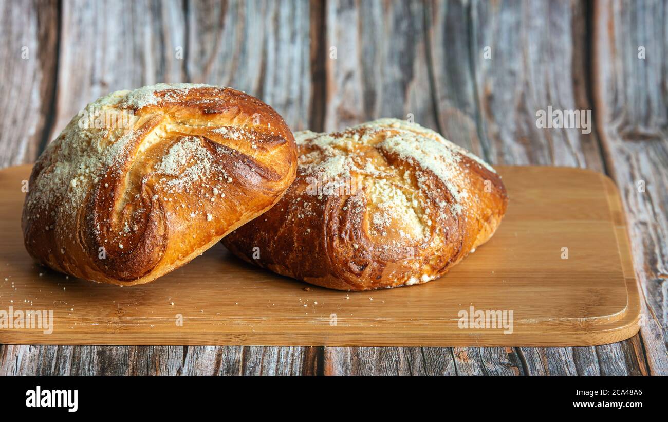 Baked sweet buns on a wood table Stock Photo - Alamy