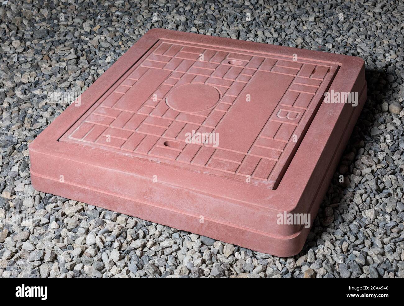 Plaster graceful stone manhole shape on the ground Stock Photo - Alamy