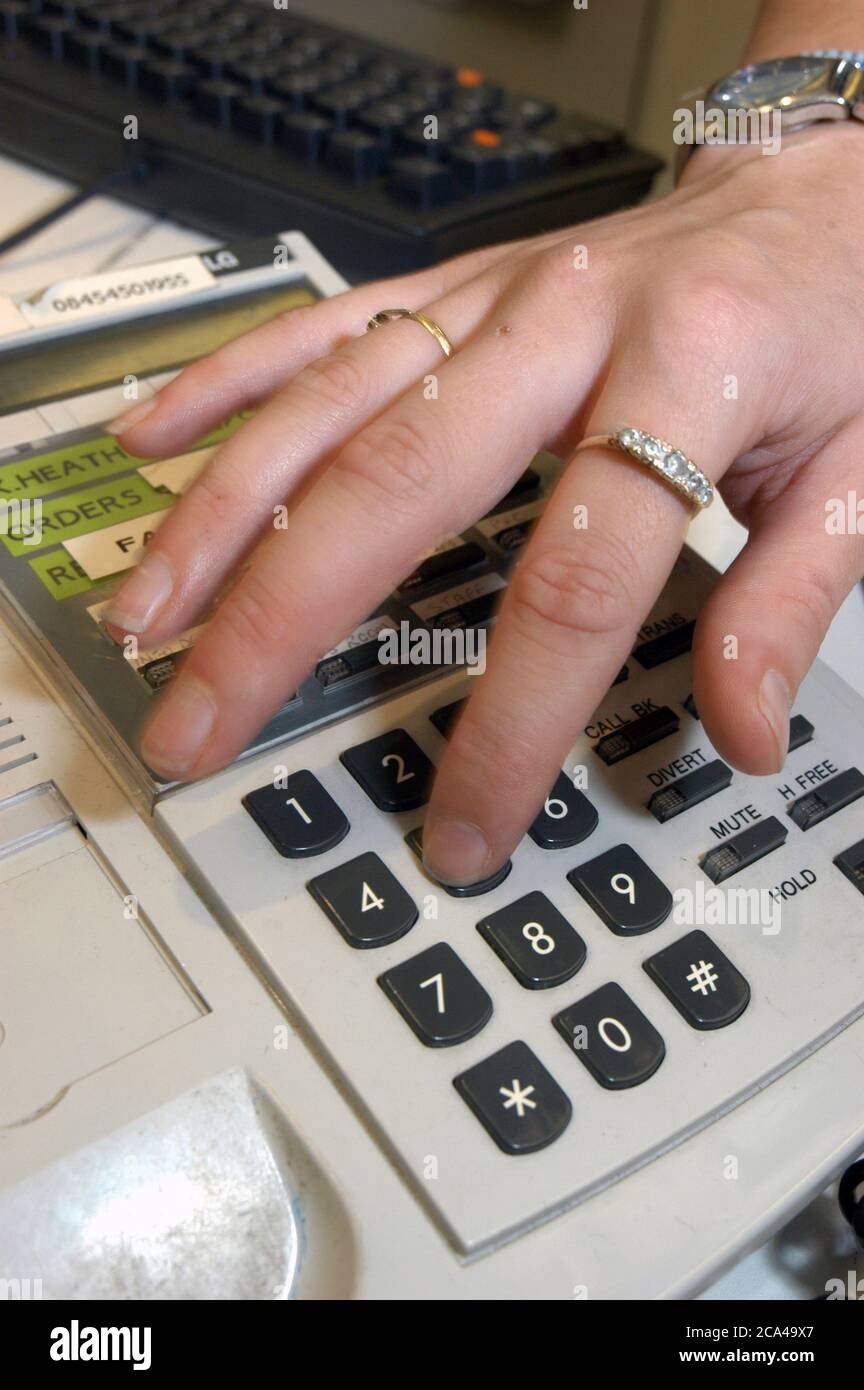 Shop worker using telephone in office; UK Stock Photo - Alamy