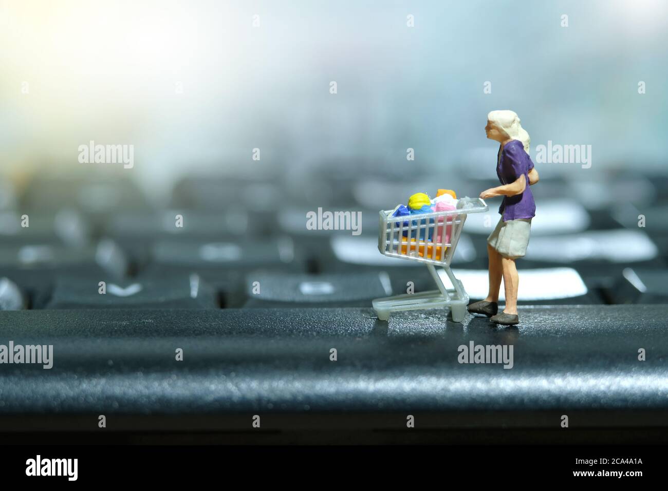 A woman doing safe solo shopping at supermarket wearing a face mask ...