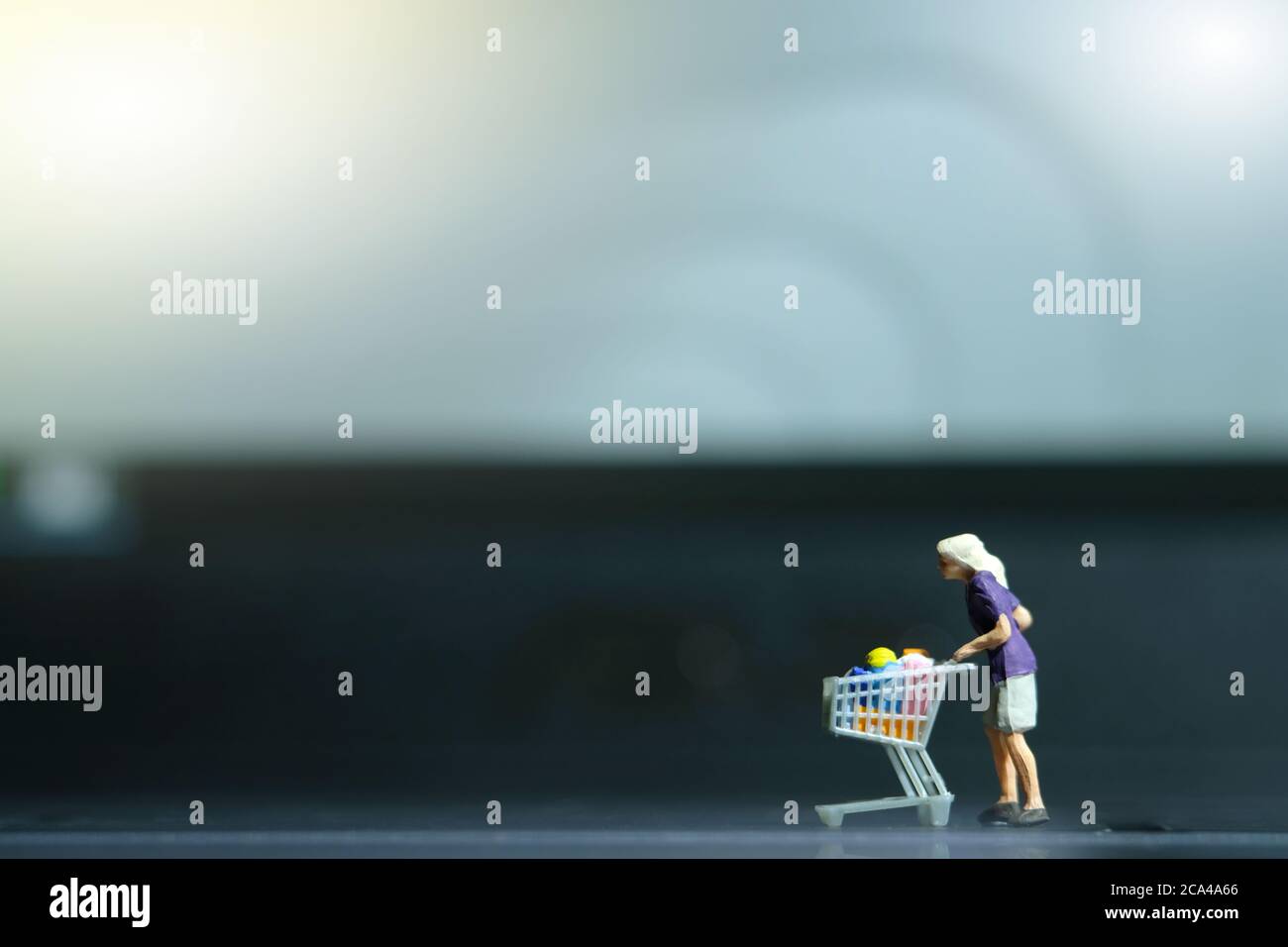 A woman doing safe solo shopping at supermarket wearing a face mask ...