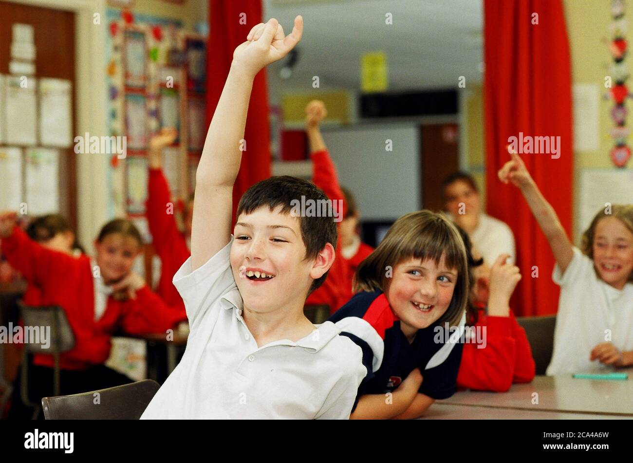 Uk school children hands up hi-res stock photography and images - Alamy