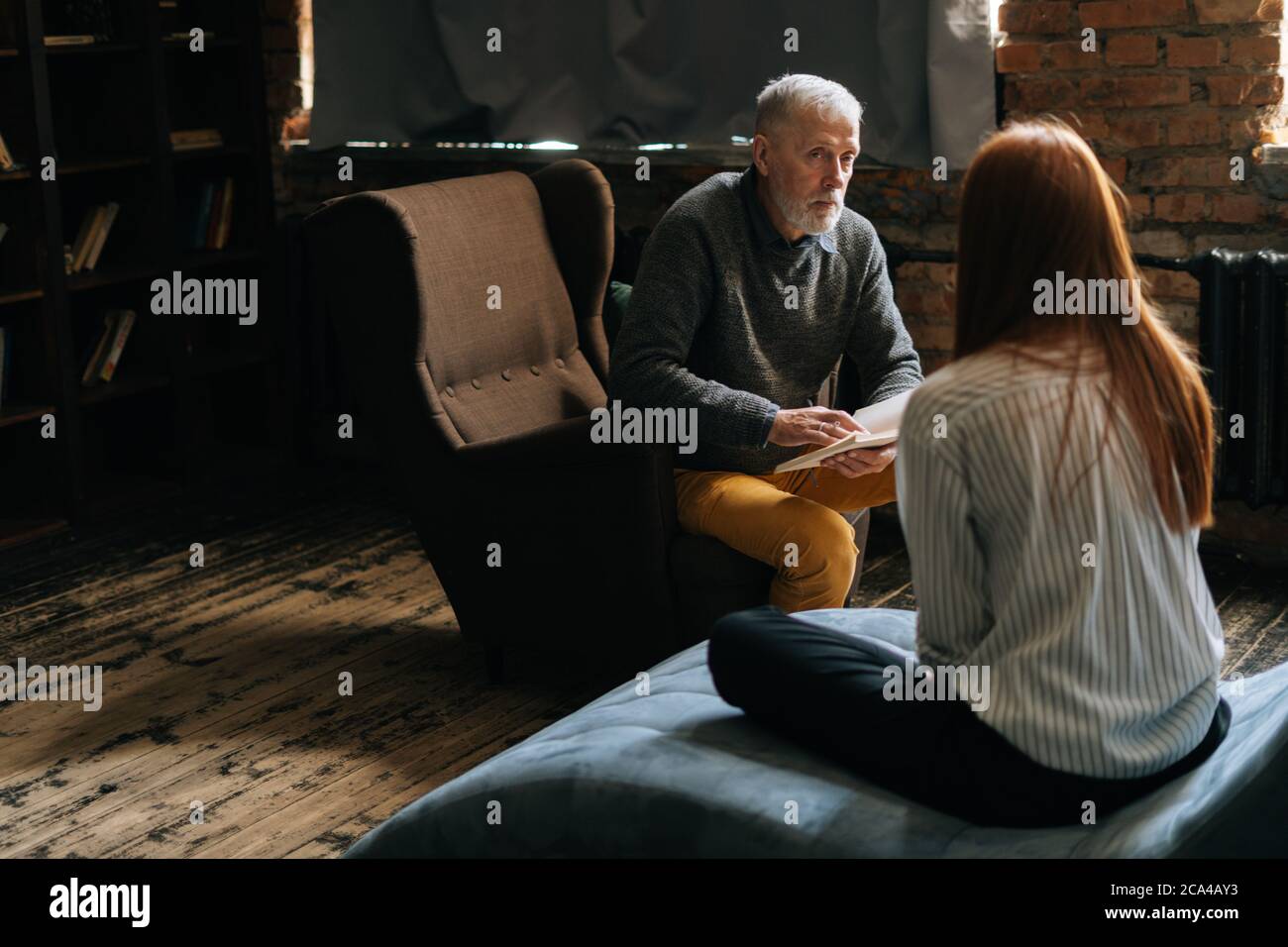 Mature man psychologist consulting female patient at psychological ...