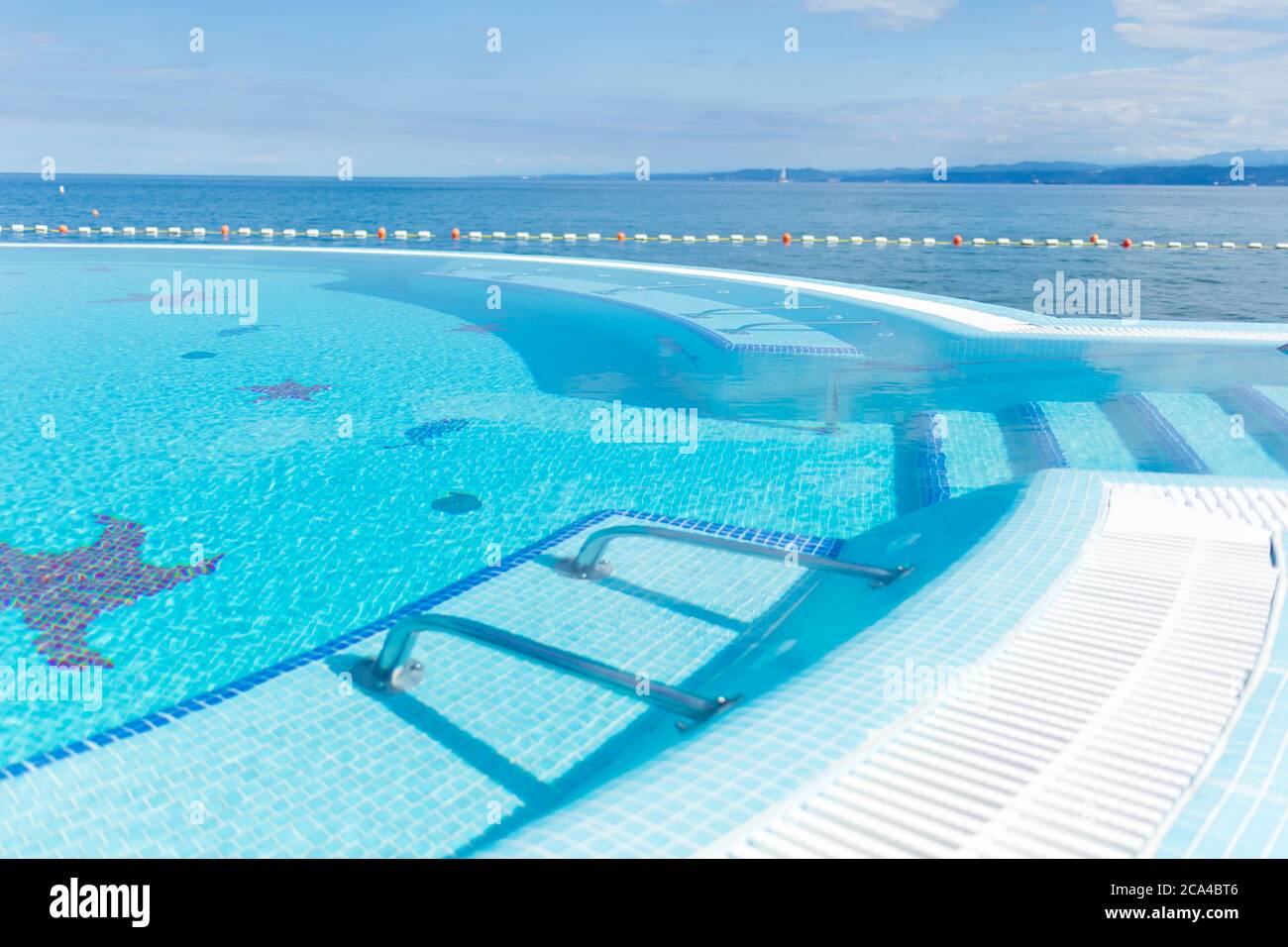 Swimming pool and blue water at the resort with beautiful sea view ...