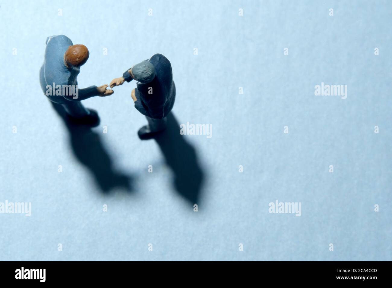 Top view of two businessmen make an handshake partnership agreement ...