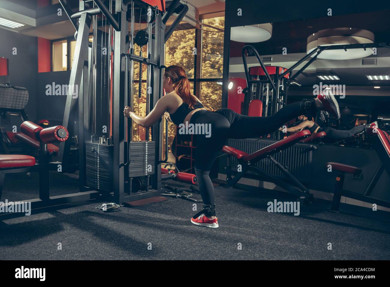 Beauty. Young muscular caucasian woman practicing in gym with equipment ...