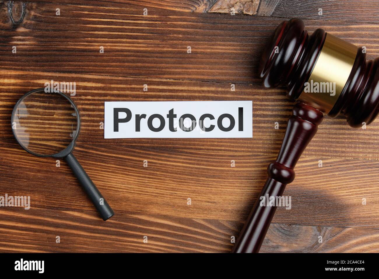 Concept of a court document as a protocol next to the judge magnifying ...