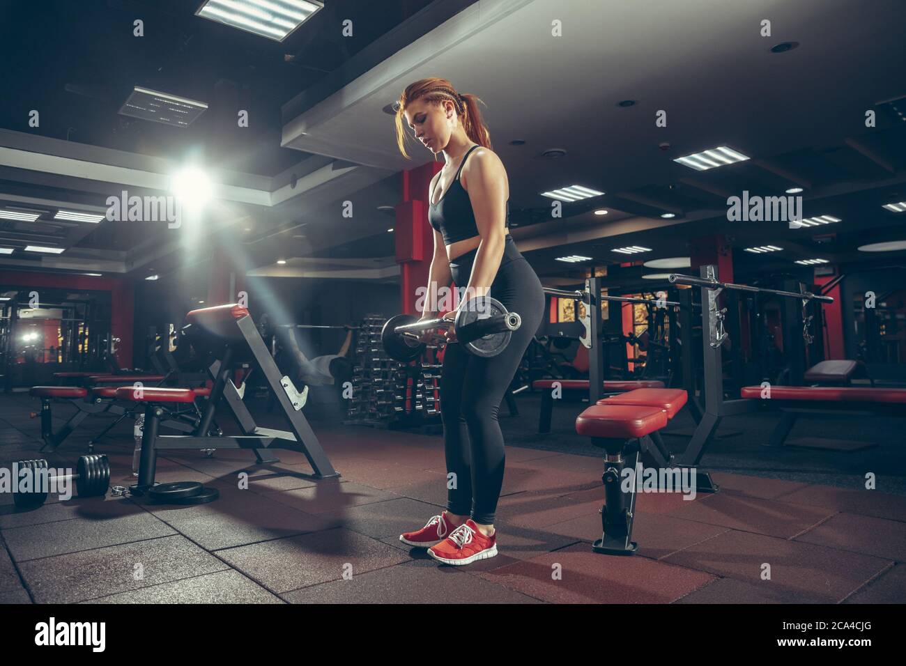 Beauty. Young muscular caucasian woman practicing in gym with equipment ...
