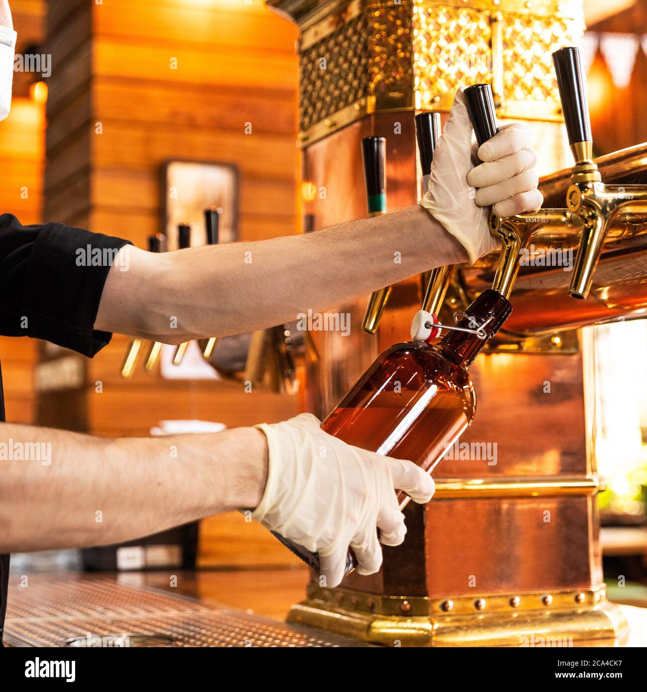 Man pouring, filling beer glass, mug Stock Photo - Alamy