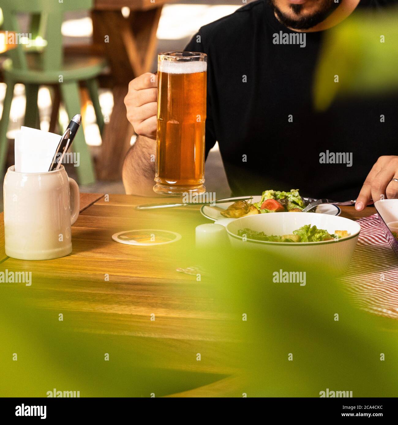 Man drinking beer with salad Stock Photo - Alamy