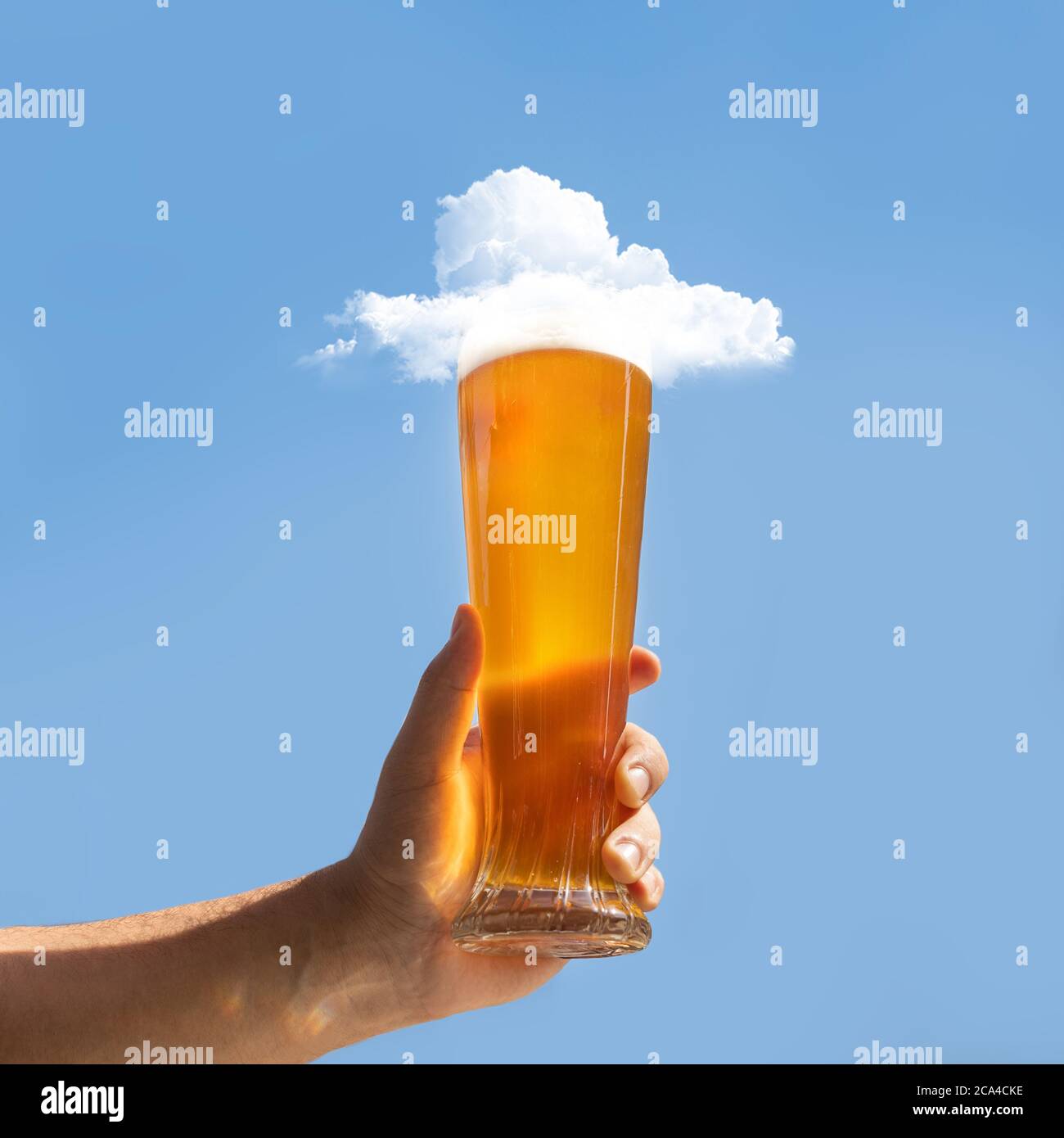 Man holding beer glass with cloud on it Stock Photo - Alamy
