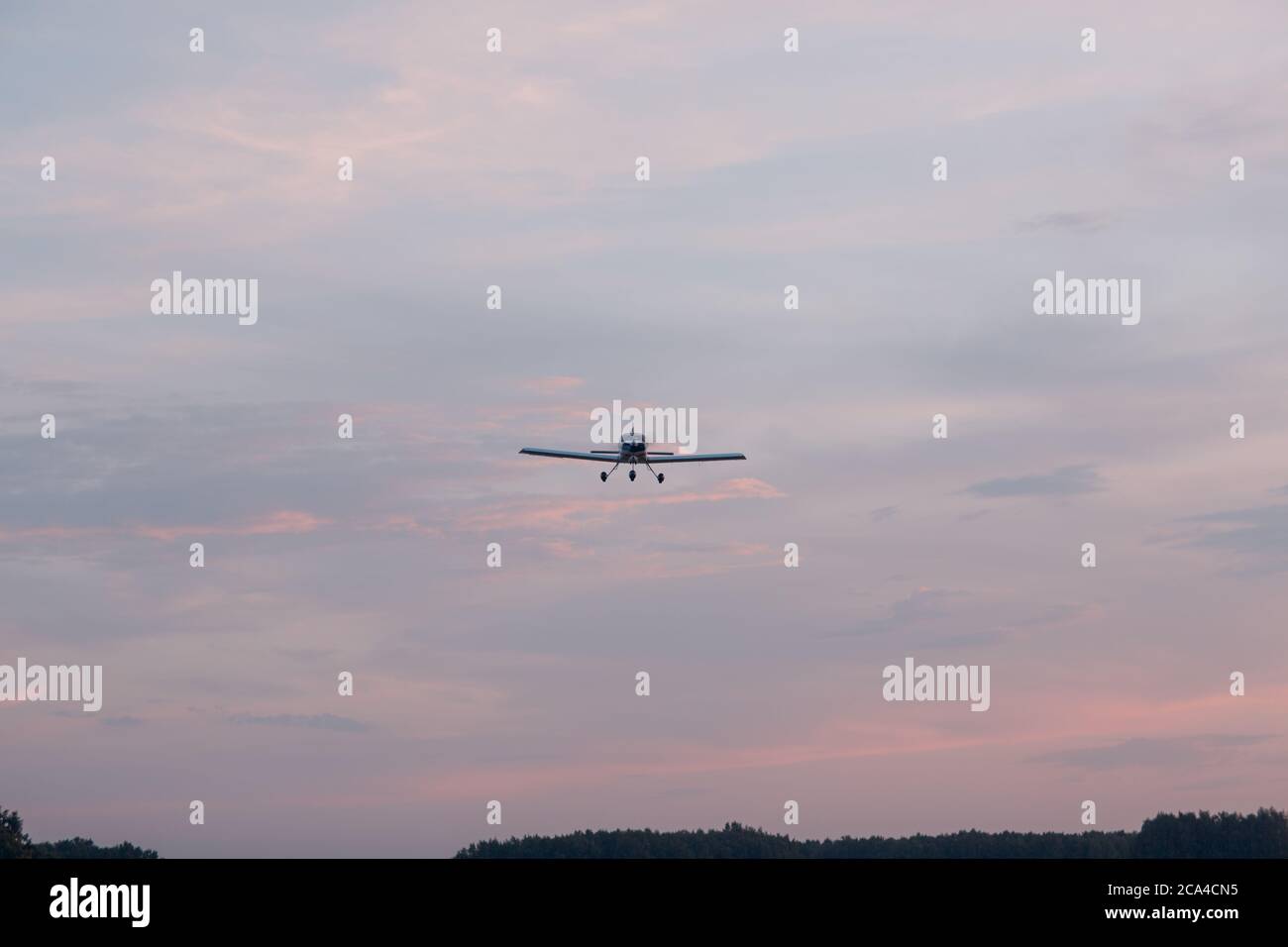 Small single engine airplane flying against sunset sky Stock Photo - Alamy