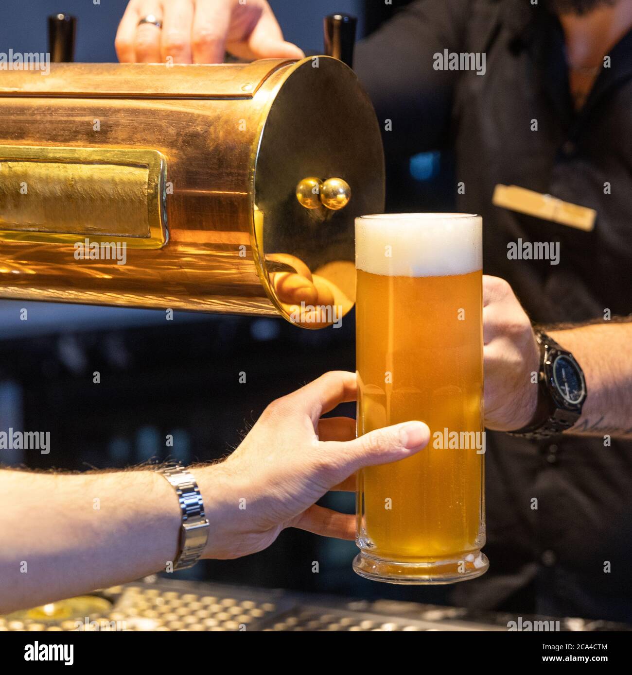 Man taking beer mug from bar Stock Photo - Alamy