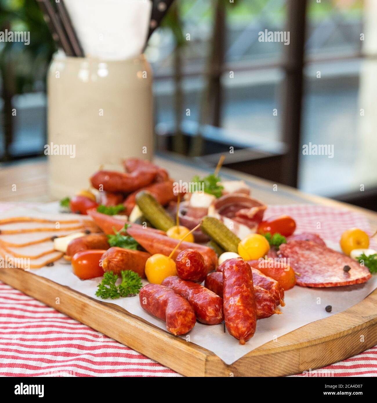 Sausage with cheese and fermented cucumbers, snacks on the table Stock ...