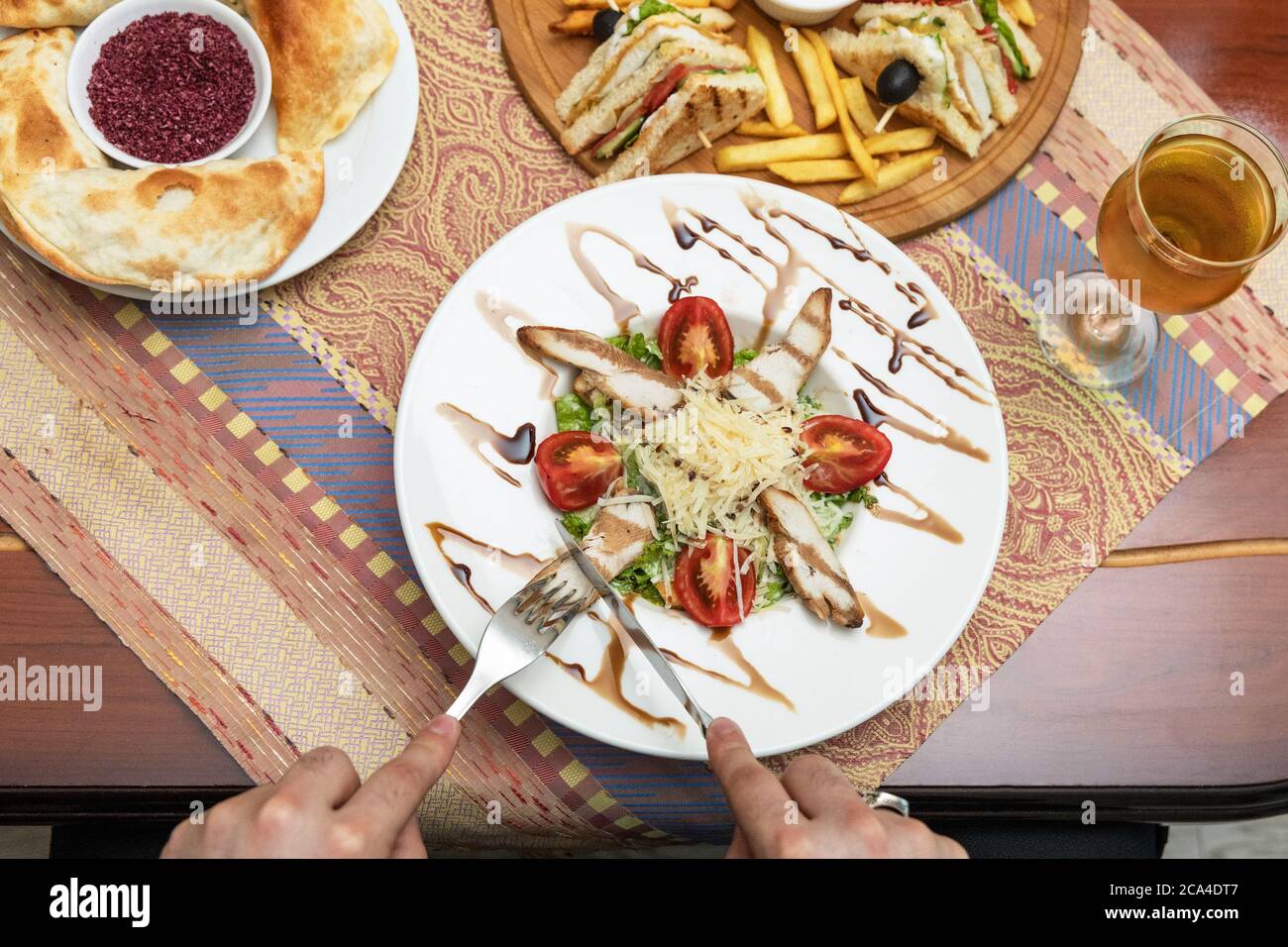 Man eating beautiful chicken salad, top view Stock Photo - Alamy