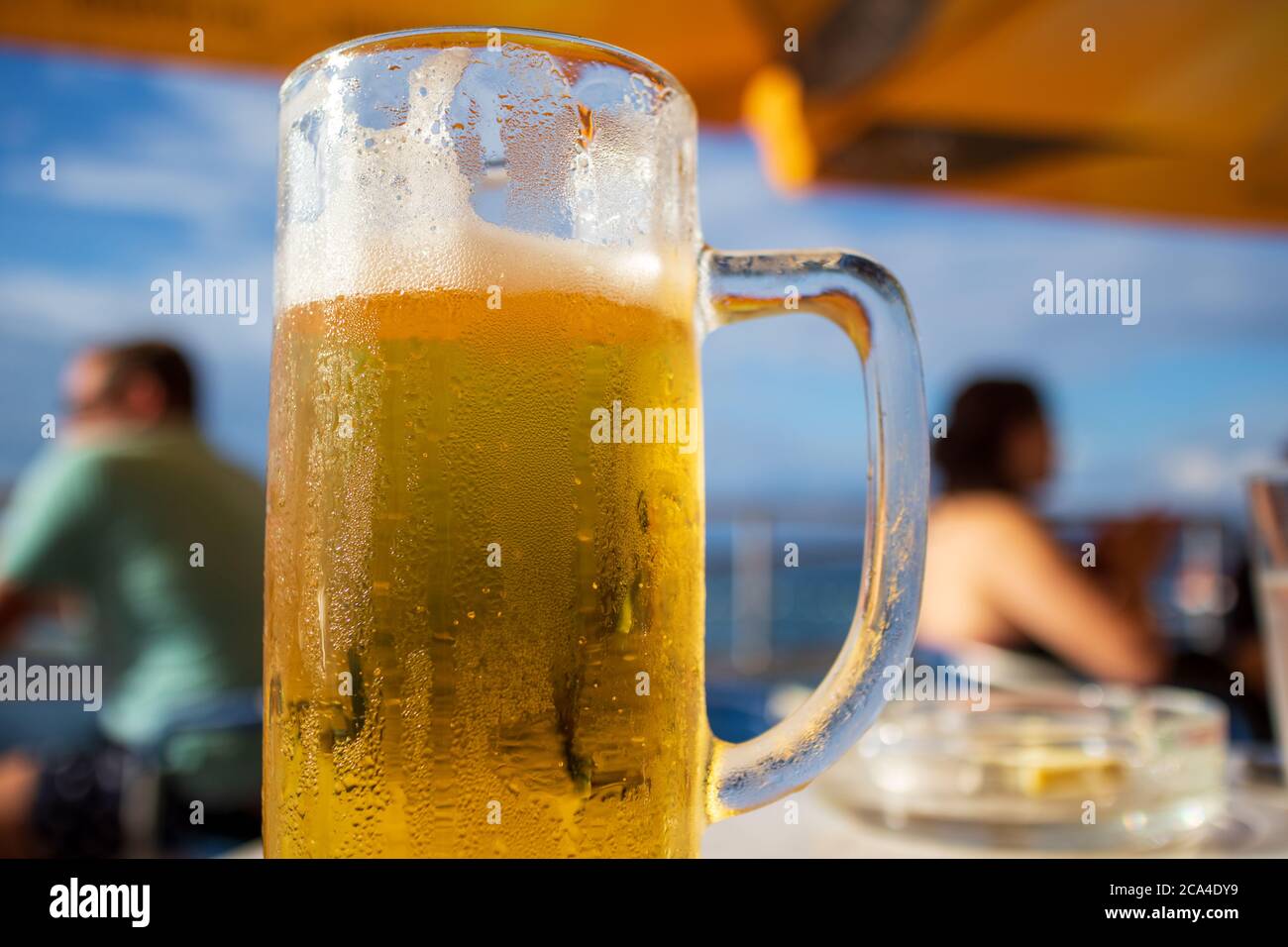 Cold Beer on a beach in big glass Stock Photo - Alamy
