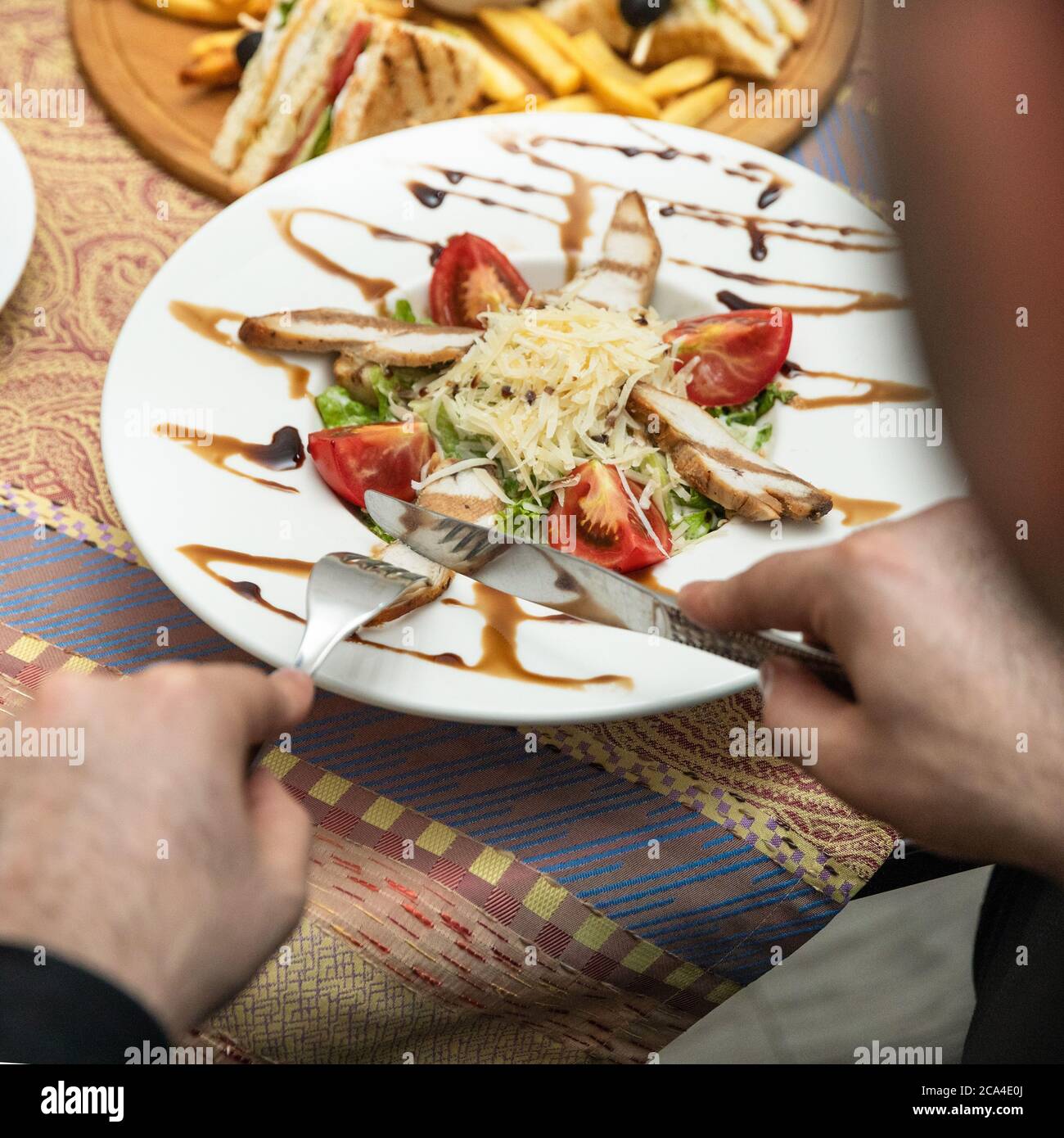 Man eating beautiful chicken salad, top view Stock Photo - Alamy
