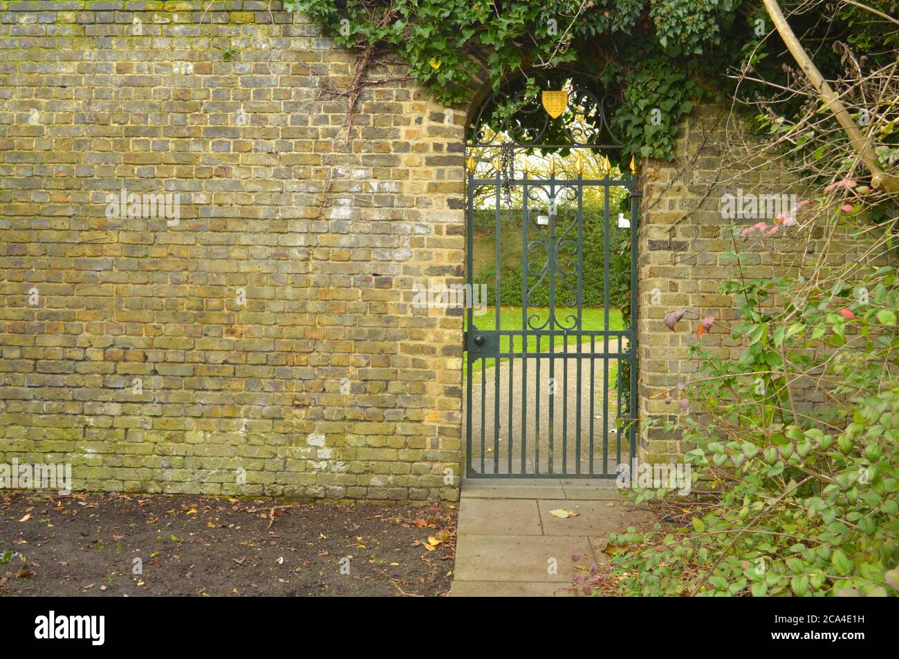 Metal gate brick wall home hi-res stock photography and images - Alamy
