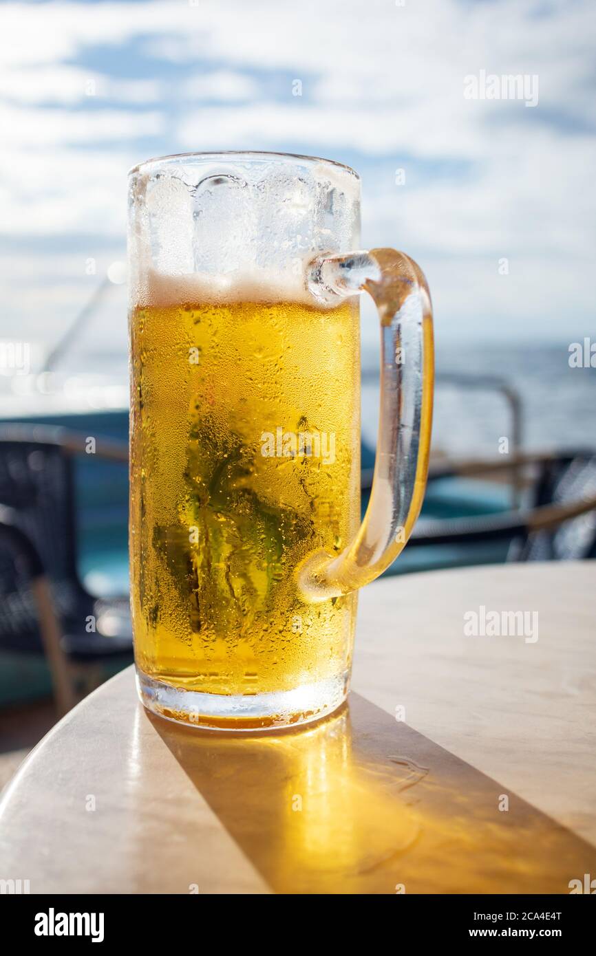 Cold Beer on a beach in big glass Stock Photo - Alamy