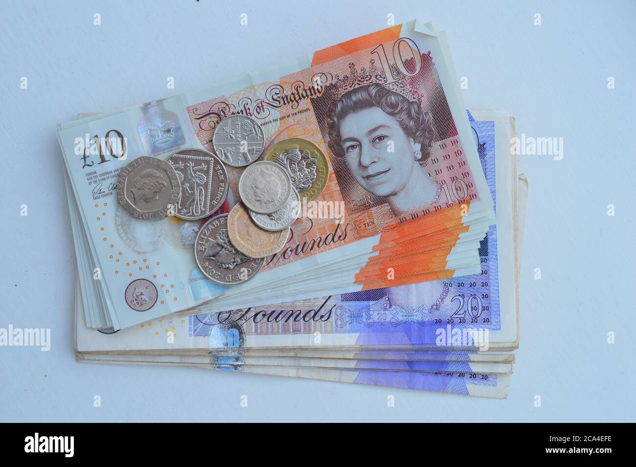UK currency on white background with a yellow maple leaf Stock Photo ...