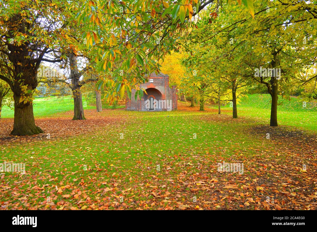 ancient red building amongst trees in the fall Stock Photo - Alamy