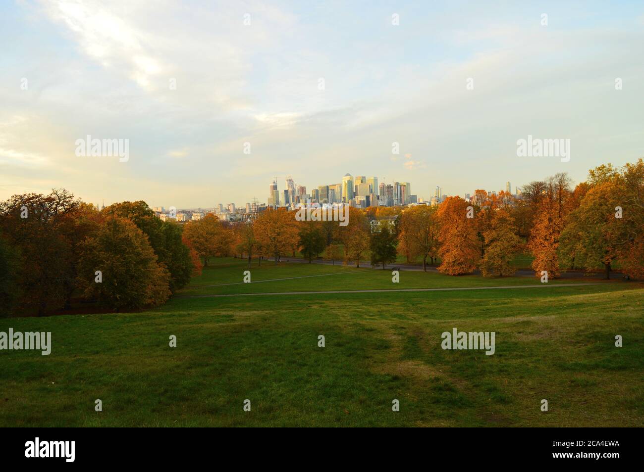 landscape with green grass and colorful trees with London skyline in ...