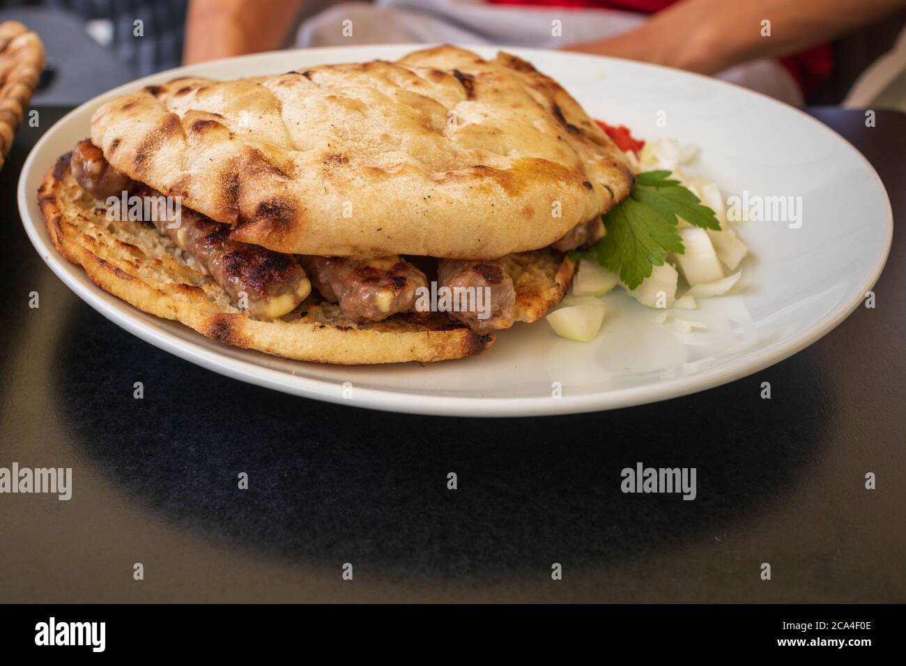Cevapcici or Cevapi, Bosnian dish prepared on the barbecue and served ...