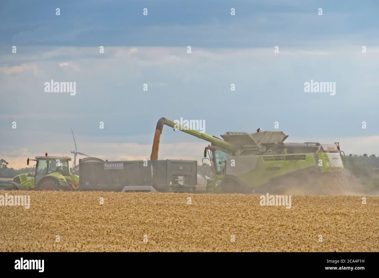 Winter Harvest combined harvester reaping crop with tractor and ...