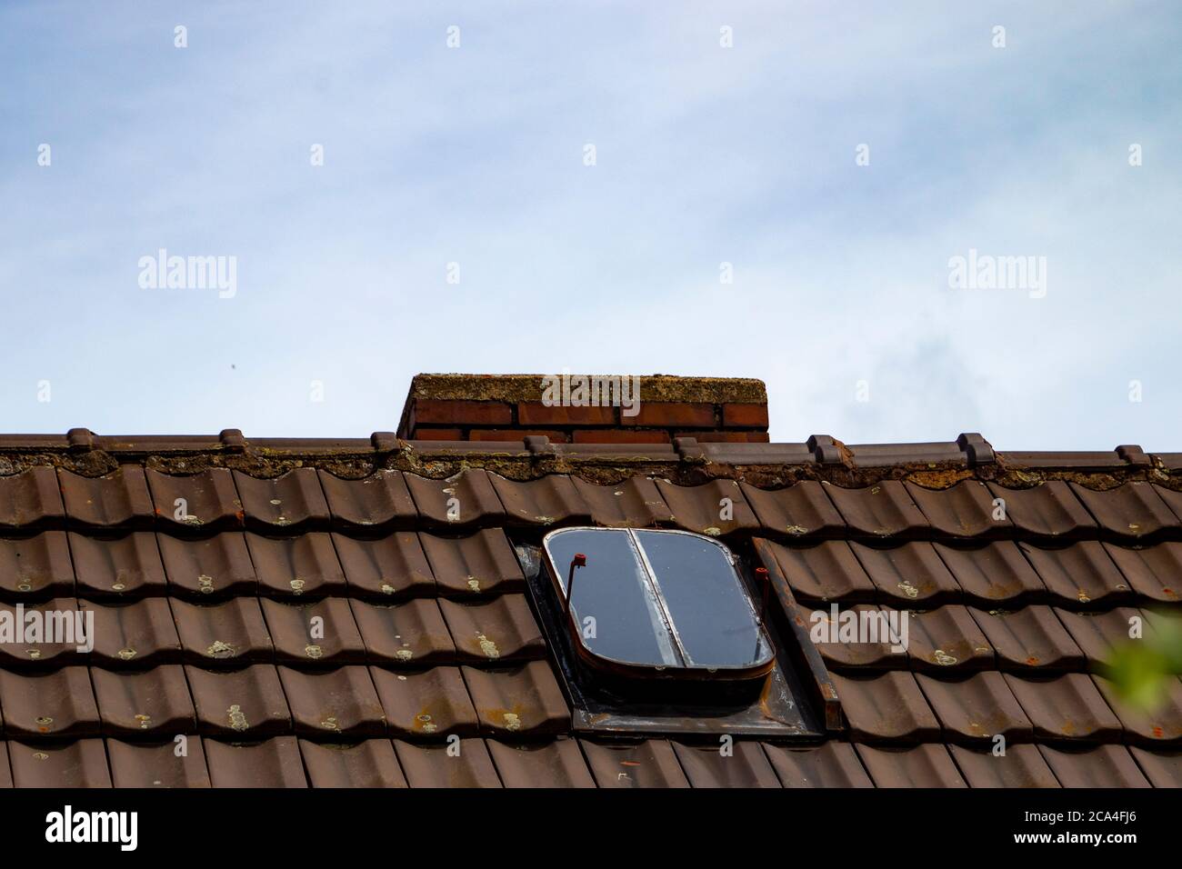 Brick chimney on an old house roof, blue sky, old roof window Stock ...