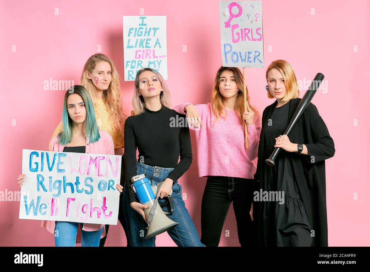 portrait of confident women fighting for women rights holding posters ...