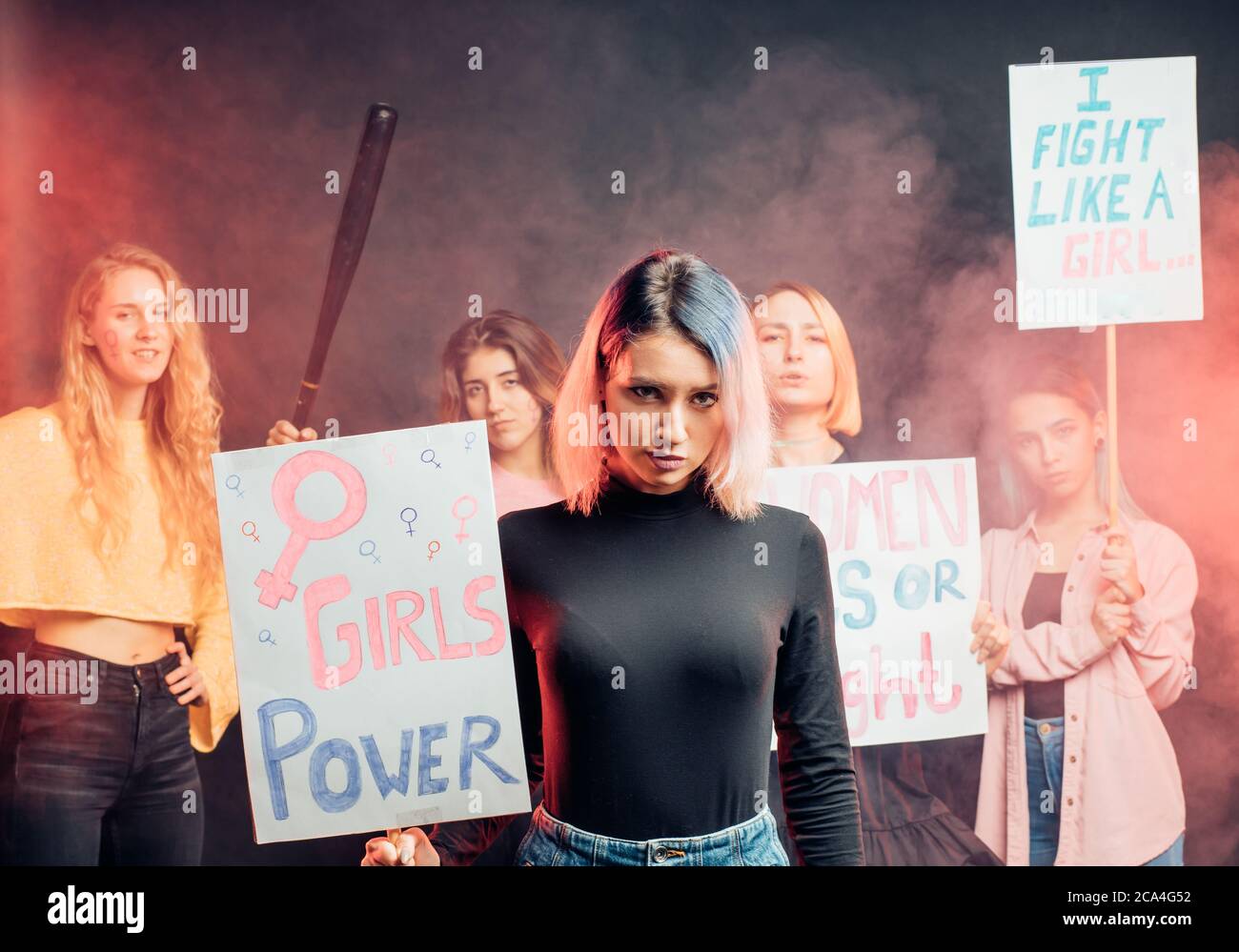 young girl fight for rights of feminists together,holding posters with ...