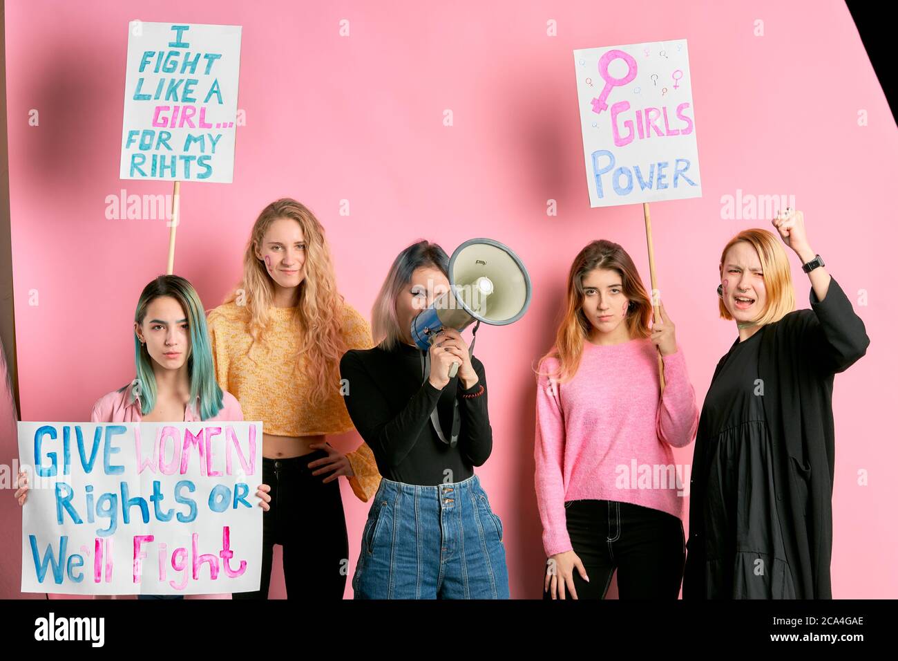 portrait of confident women fighting for women rights holding posters ...