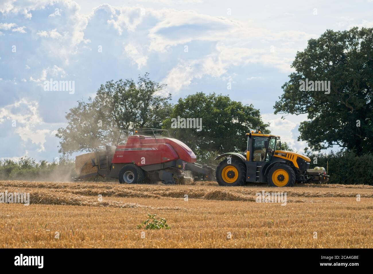 Baling after the harvest Close up view of bailer ejecting bale onto the ...
