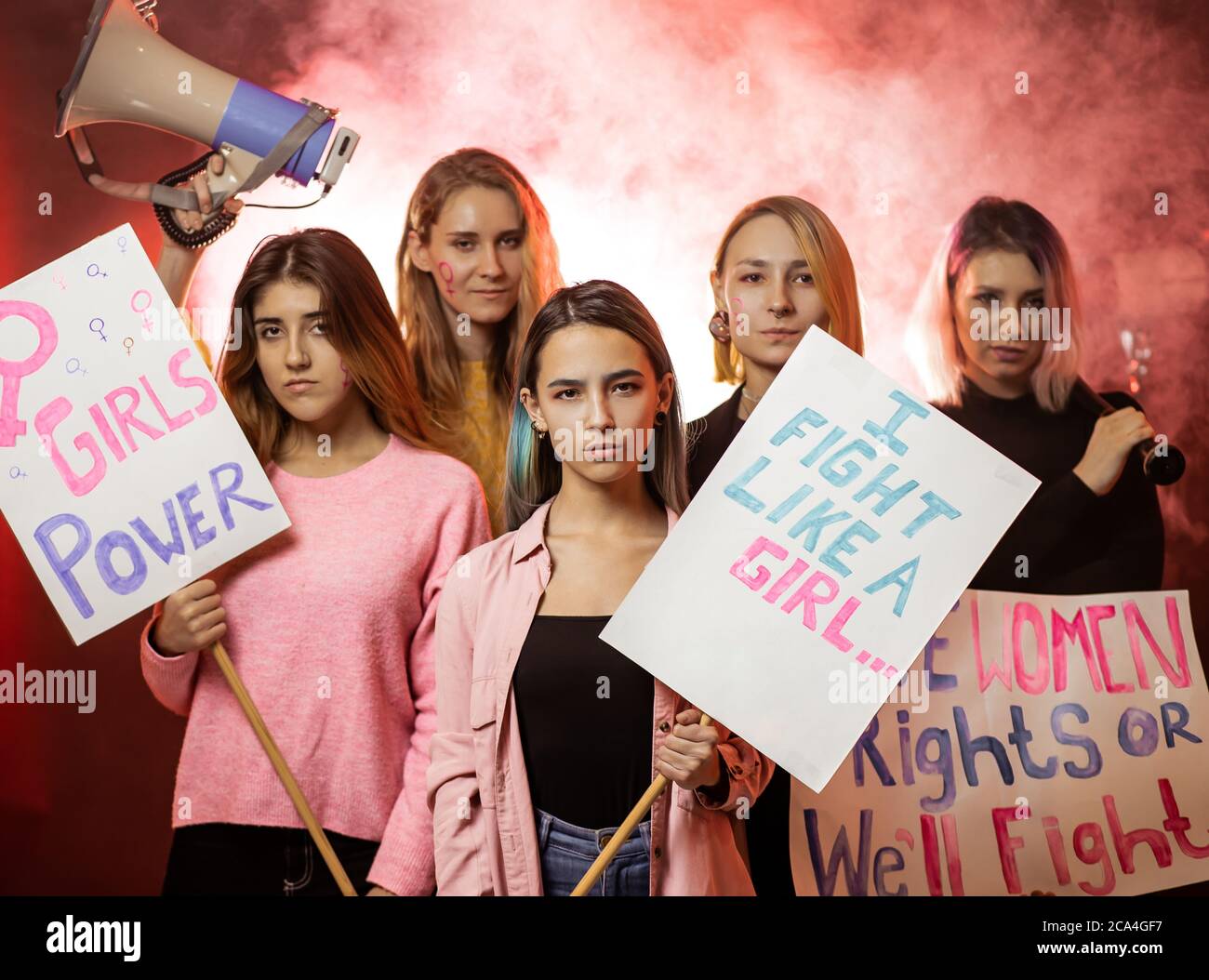 young beautiful women stand together in smoky space fighting for girls ...