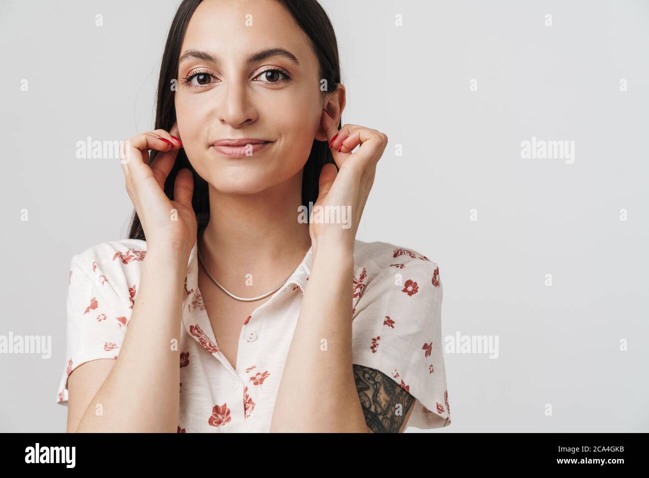 Photo of joyful beautiful woman plugging his ears and smiling isolated ...