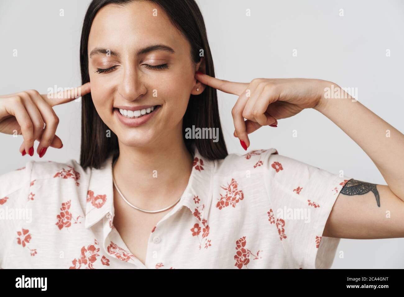 Photo of joyful beautiful woman plugging his ears and laughing isolated ...